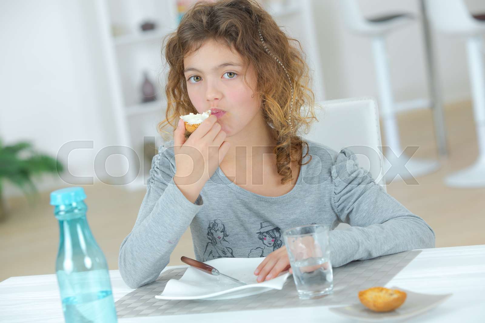 Little girl eating a snack | Stock image | Colourbox