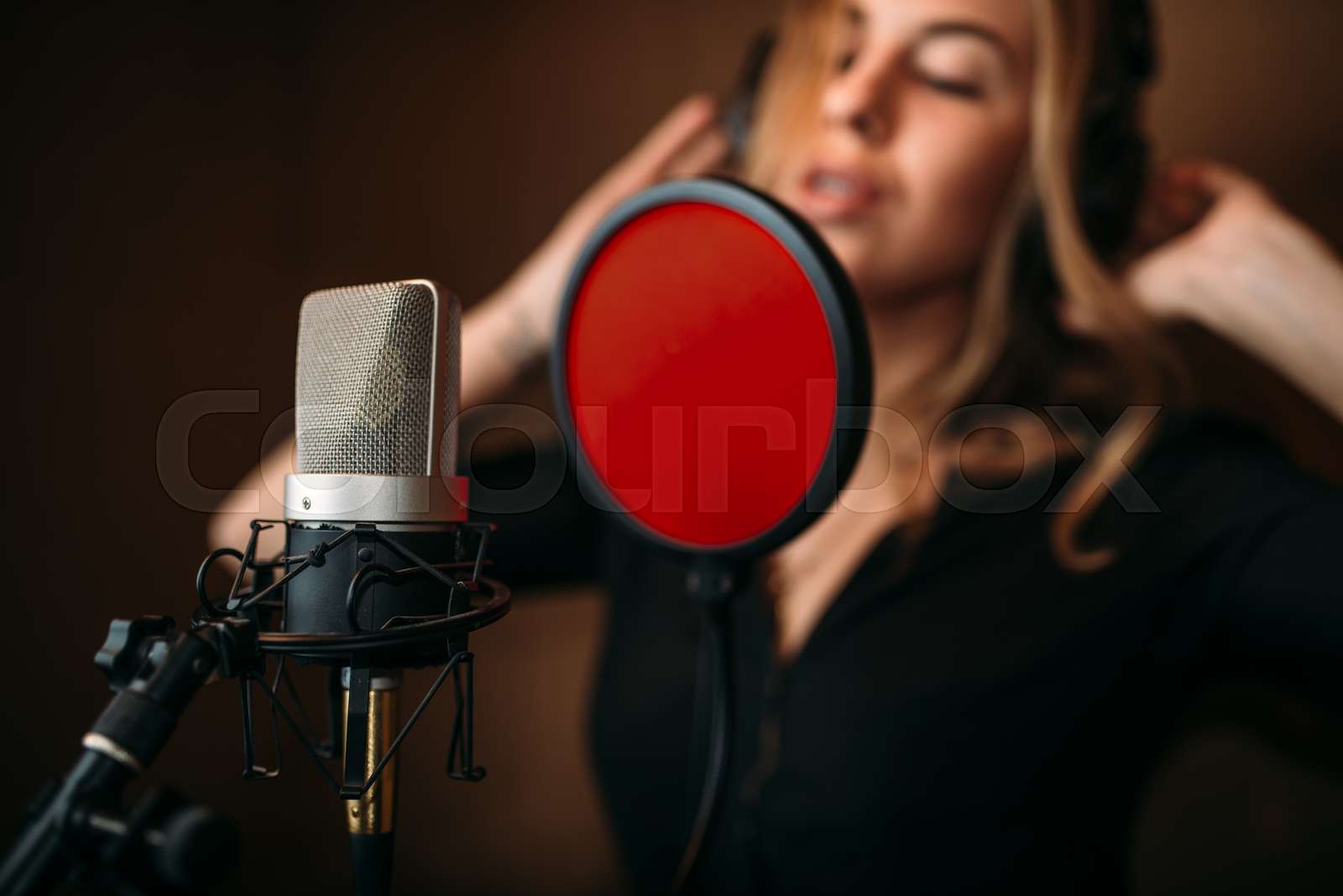 Female Singer In Headphones Against Microphone Stock Image Colourbox
