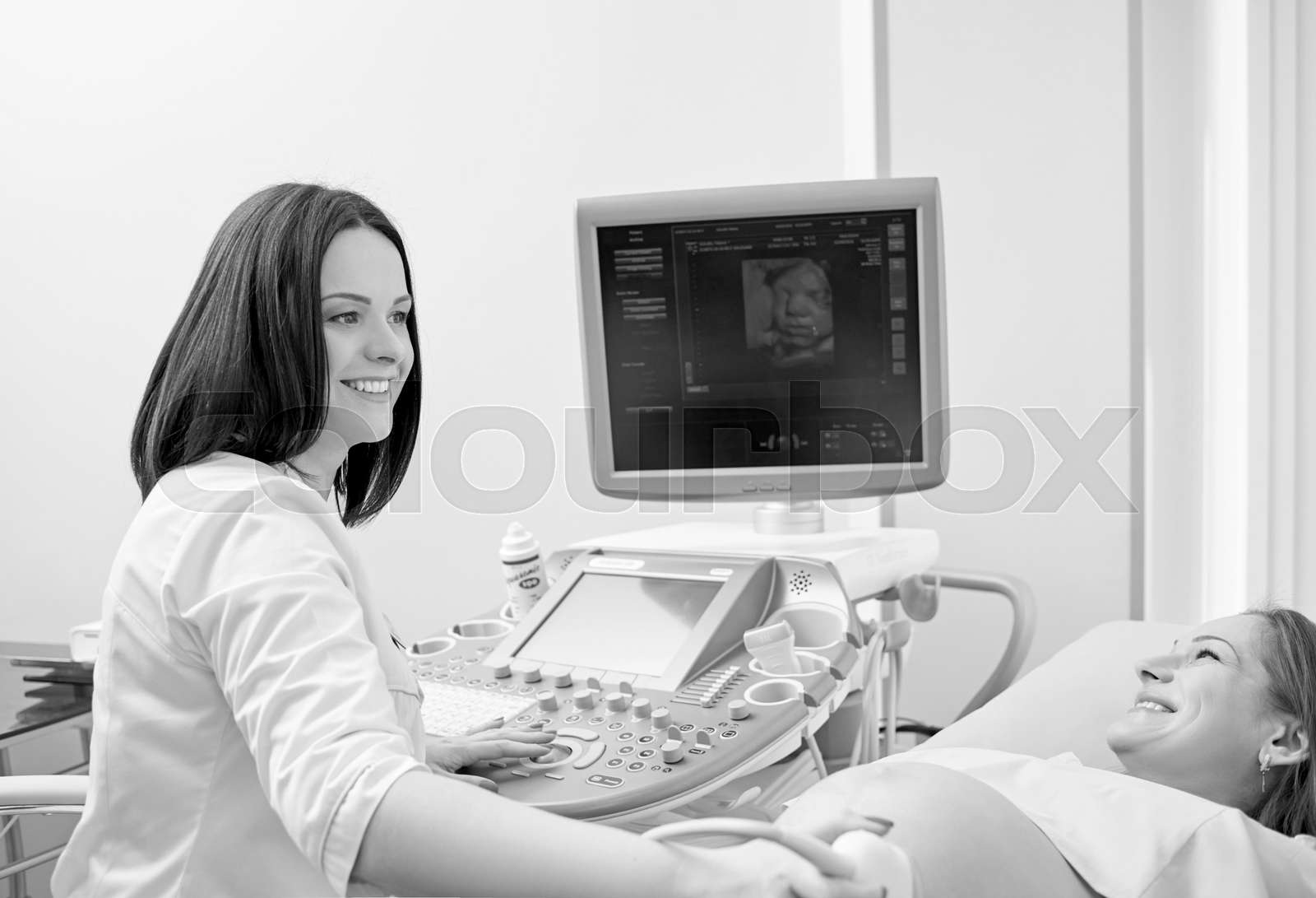Pregnant woman having ultrasonic scanning at the clinic | Stock image ...