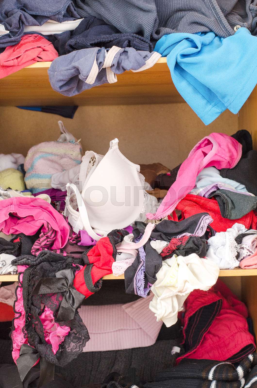 Pile of carelessly scattered clothes in wardrobe | Stock image | Colourbox