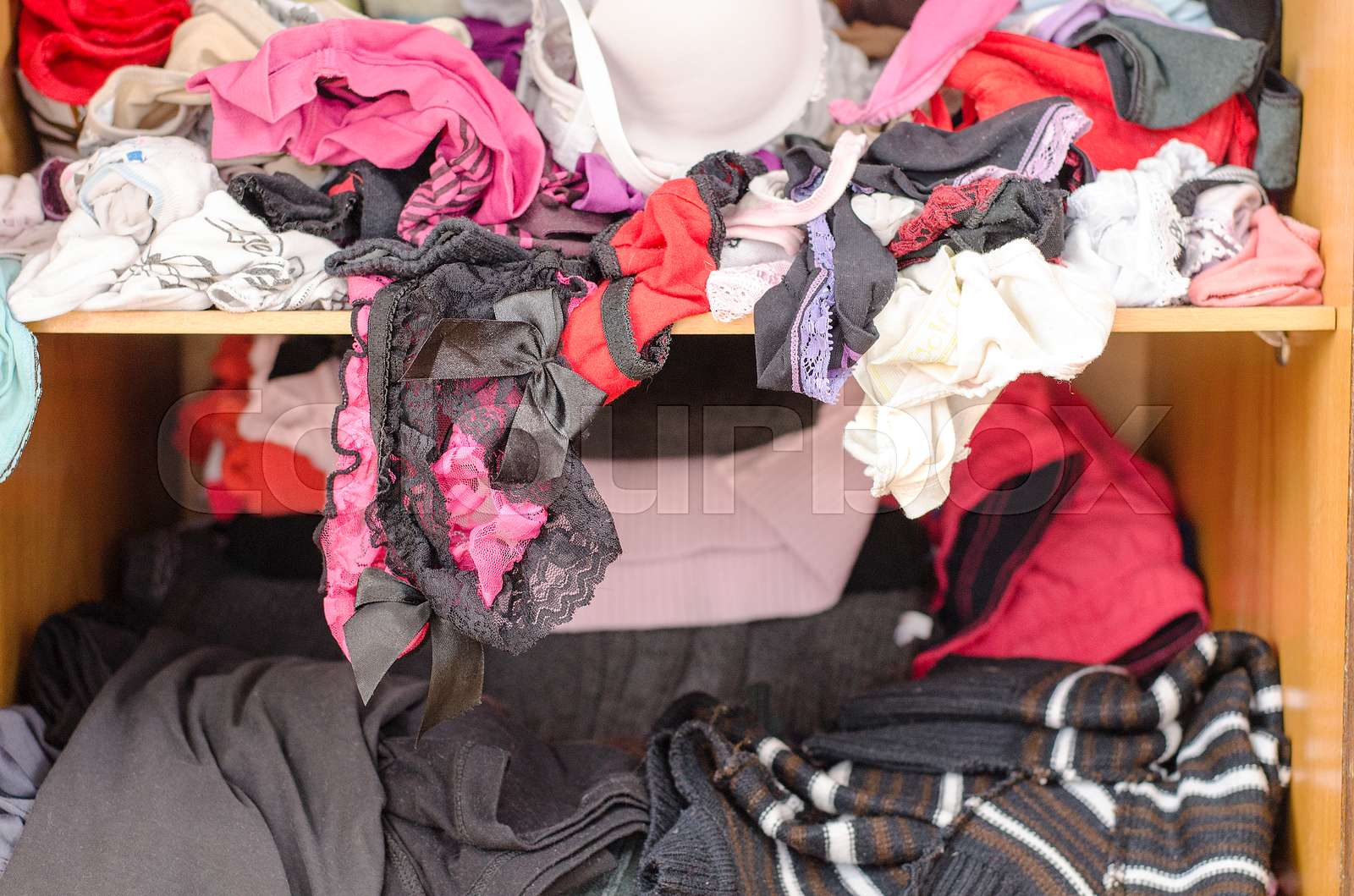 Pile of carelessly scattered clothes in wardrobe | Stock image | Colourbox