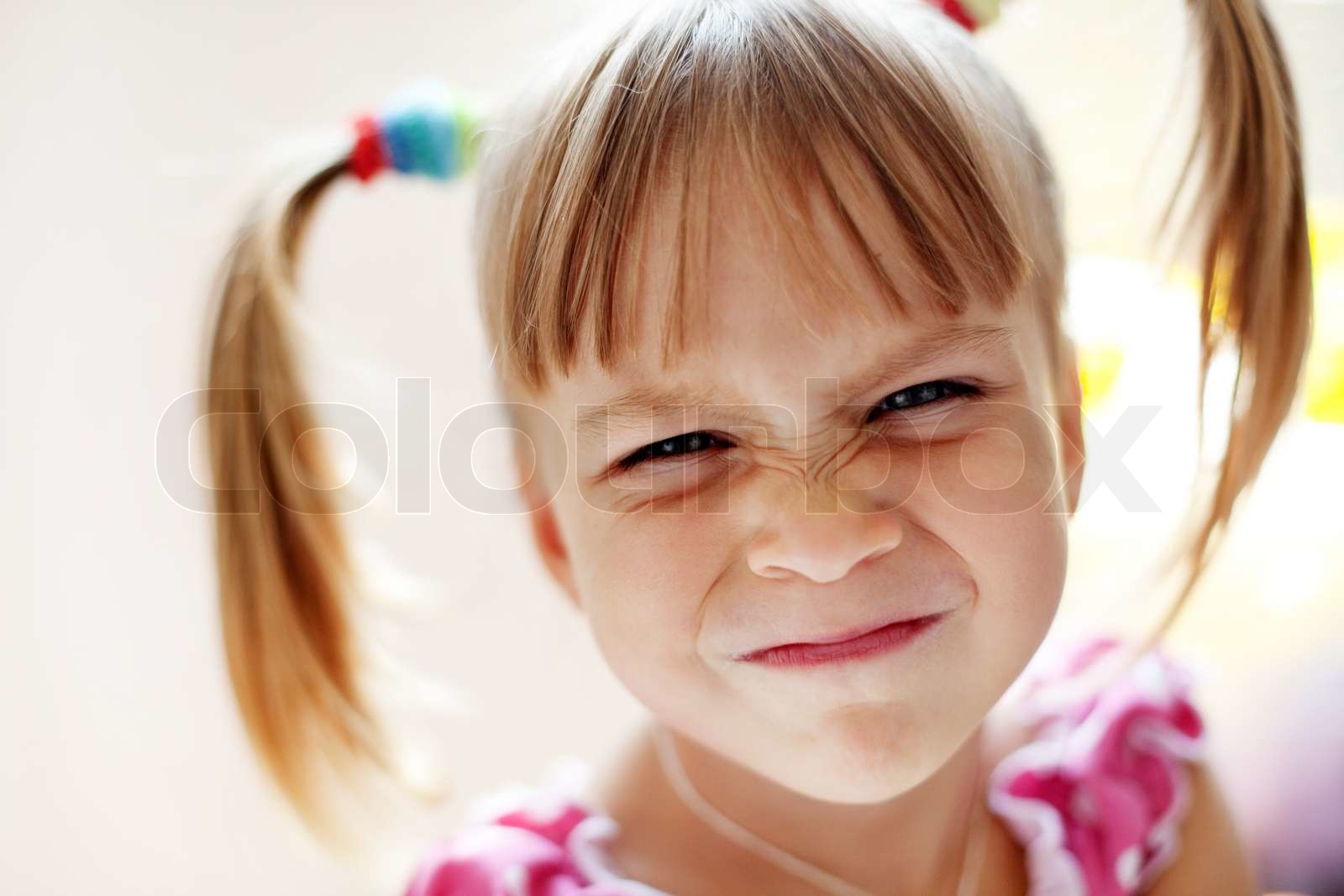 Portrait of a funny child making grimace | Stock image | Colourbox