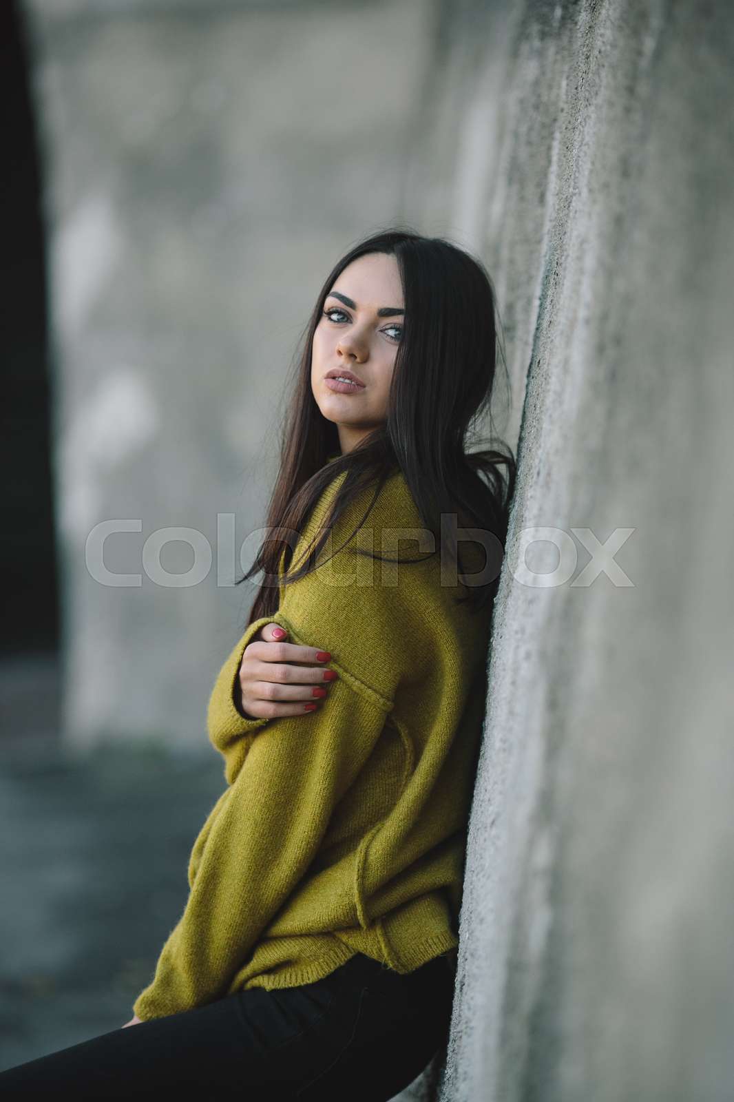 Fashion girl posing against wall | Stock image | Colourbox