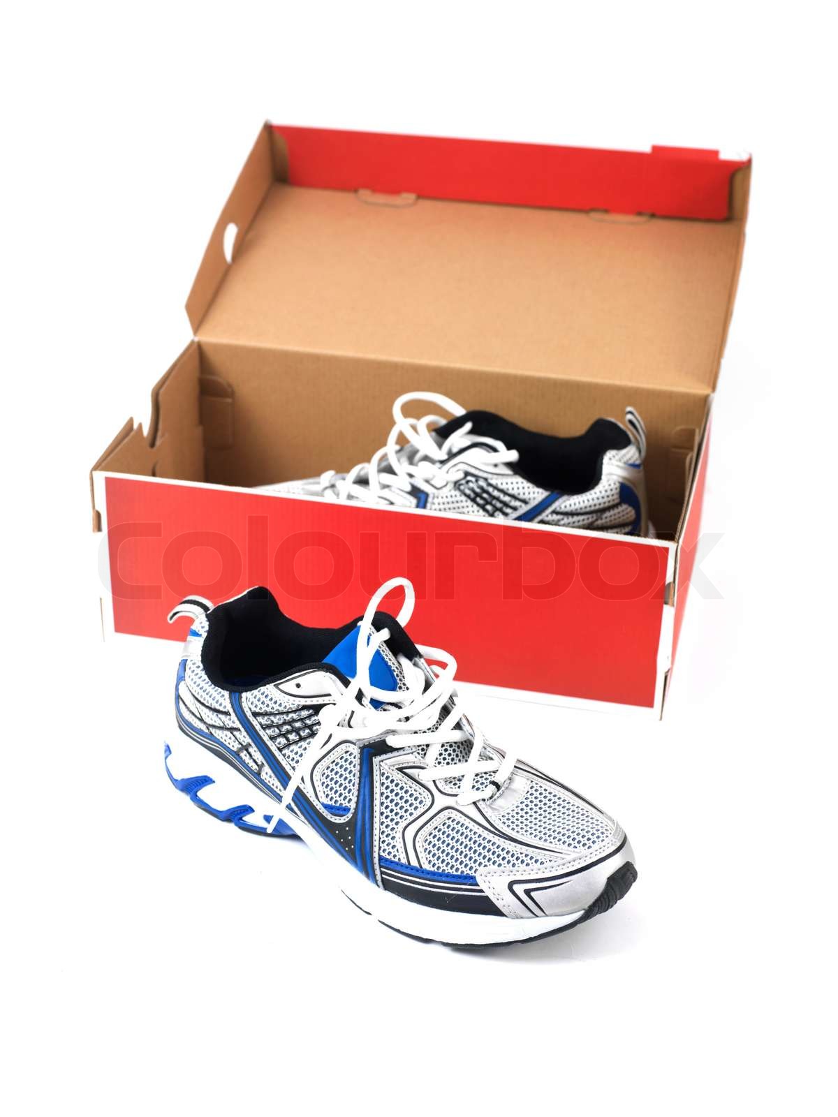 Sports runners situated in a shoe box | Stock image | Colourbox