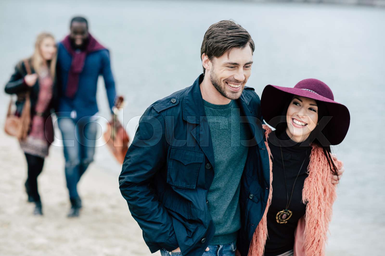 Young people having stroll on beach | Stock image | Colourbox