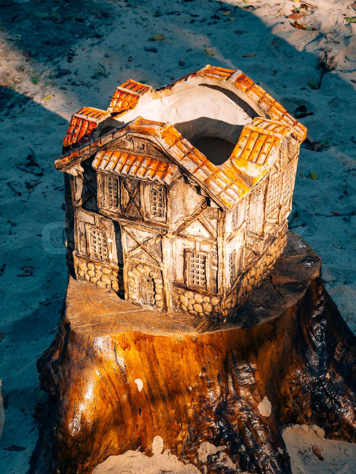 Clay house handmade on a stump in the woods. Landscape design of ...