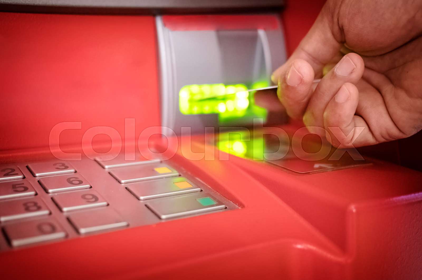 Hand inserting ATM card into bank machine to withdraw money | Stock ...