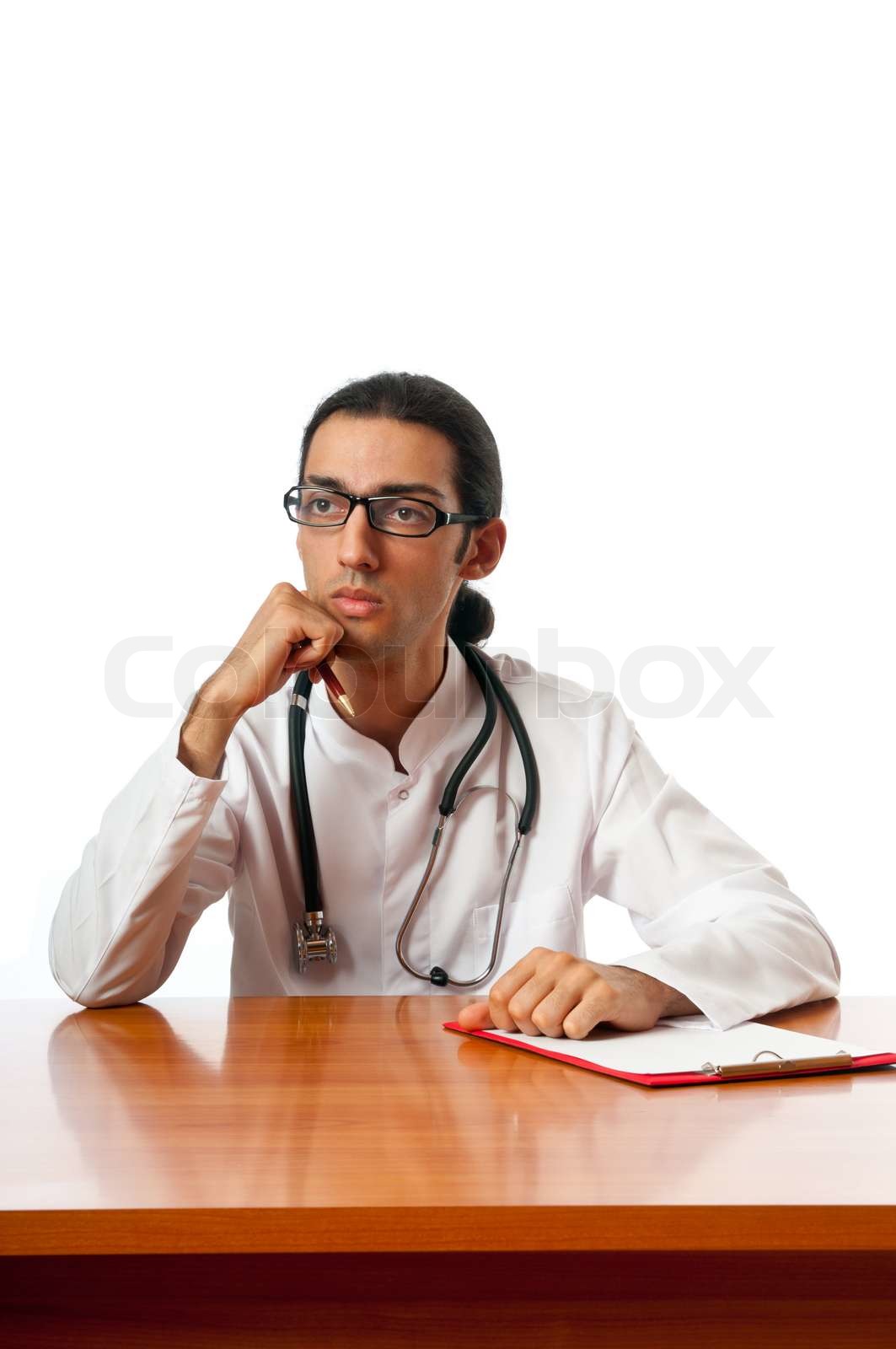 Doctor sitting at the desk on white | Stock image | Colourbox