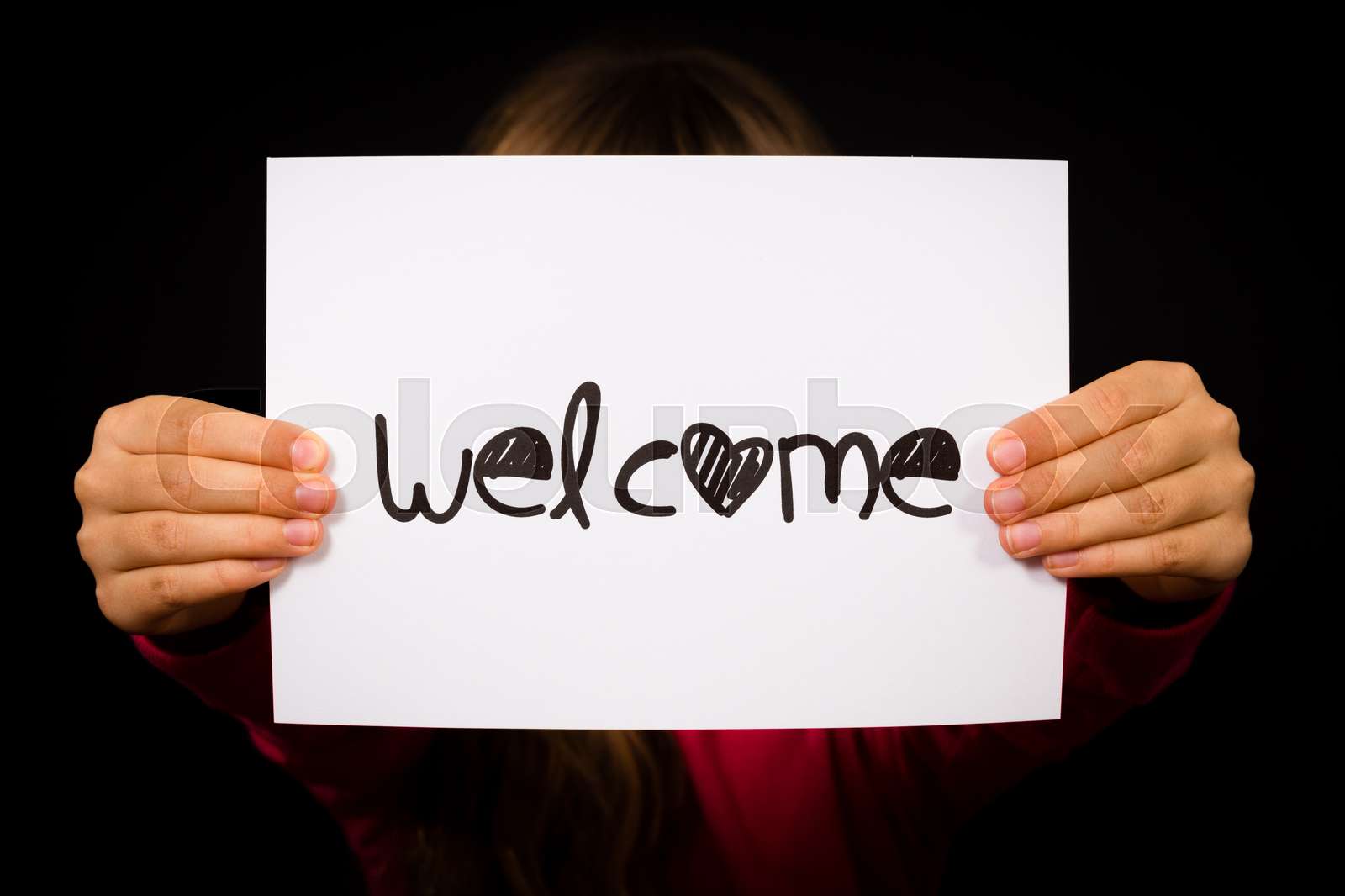 Child holding Welcome sign | Stock image | Colourbox