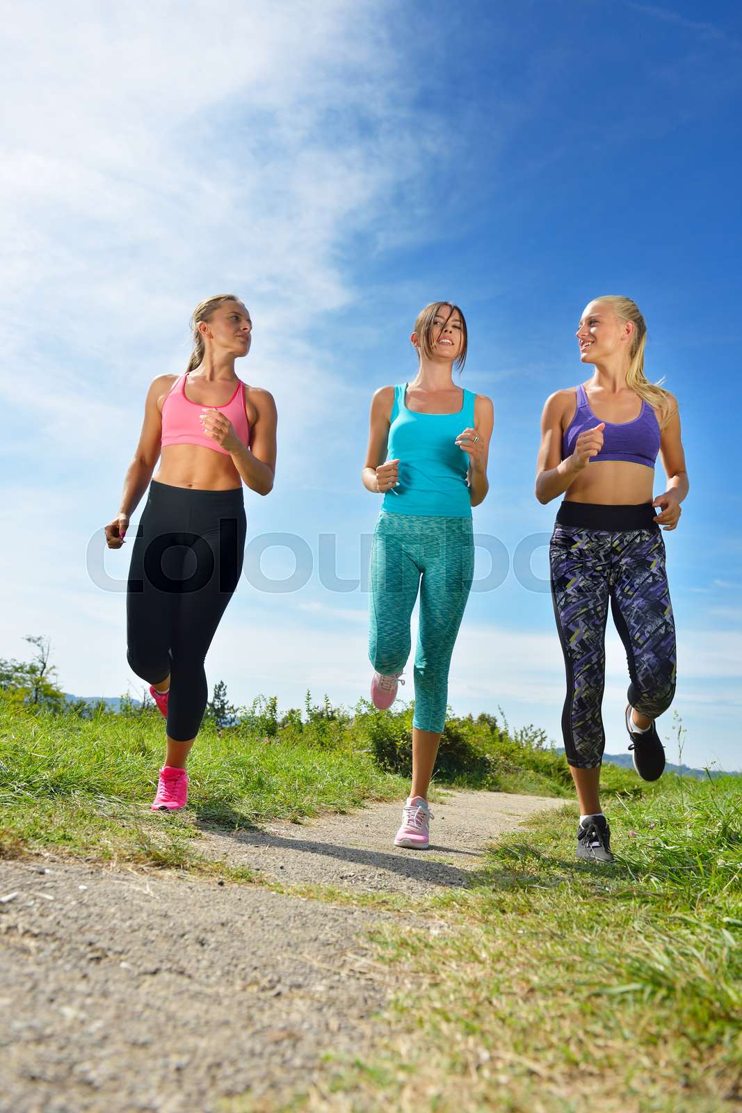 Three Female Joggers running together outdoors | Stock image | Colourbox