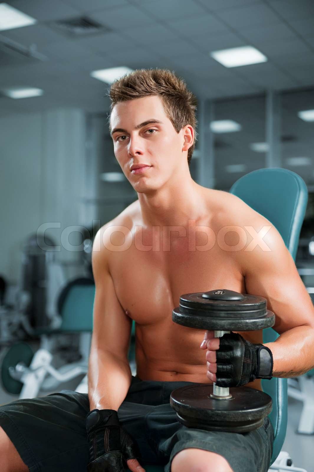 A young man working out in a gym | Stock image | Colourbox