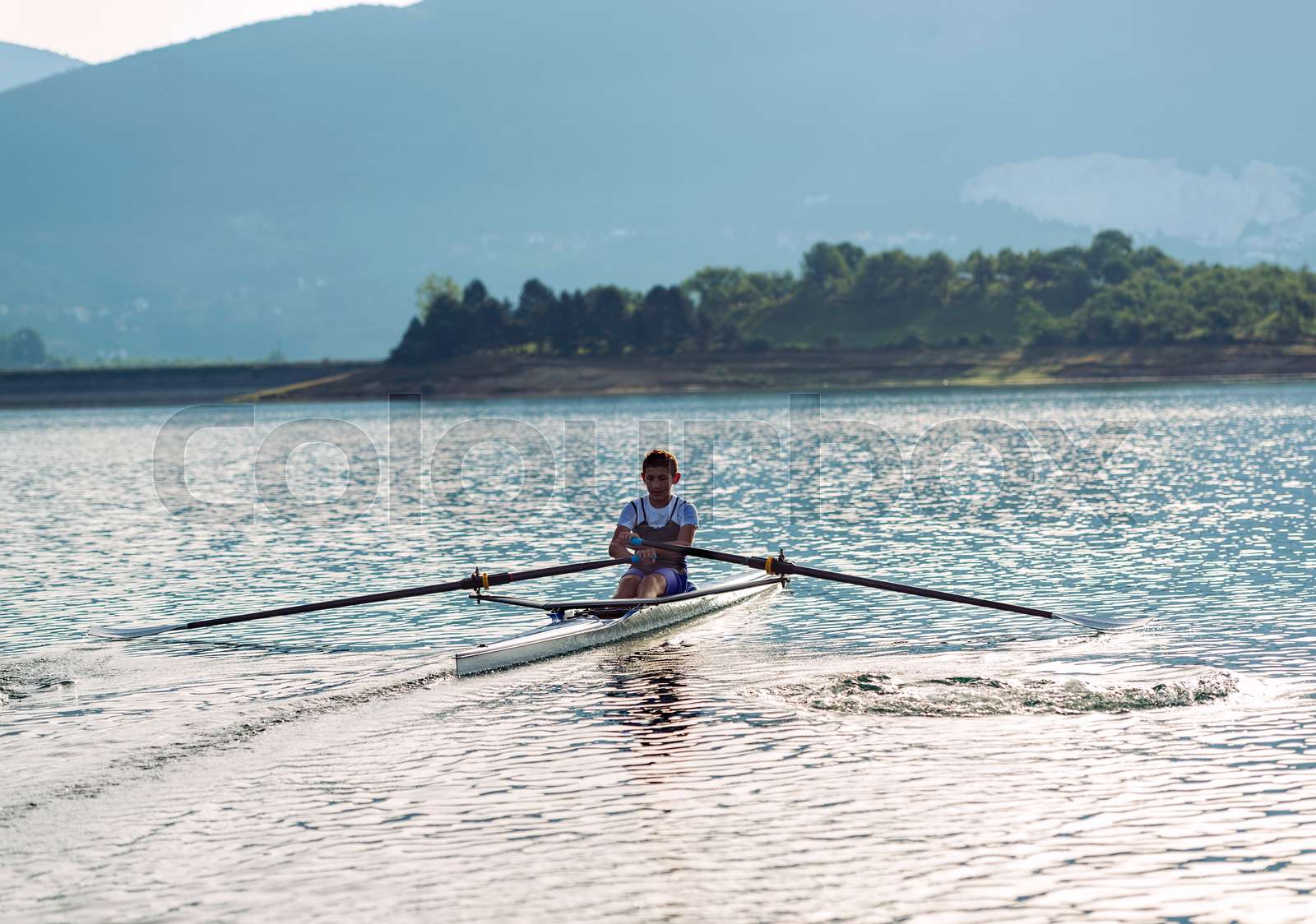Child in the course of rowing on single | Stock image | Colourbox