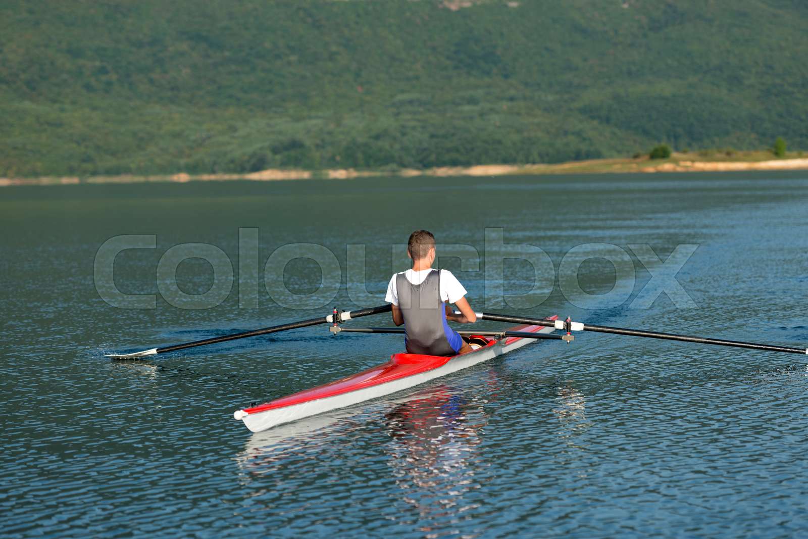 Child in the course of rowing on single | Stock image | Colourbox