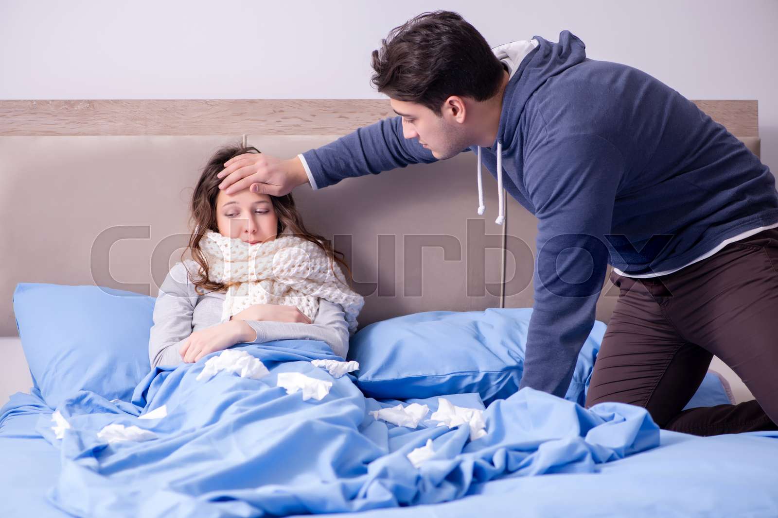 Wife caring for sick husband at home in bed | Stock image | Colourbox