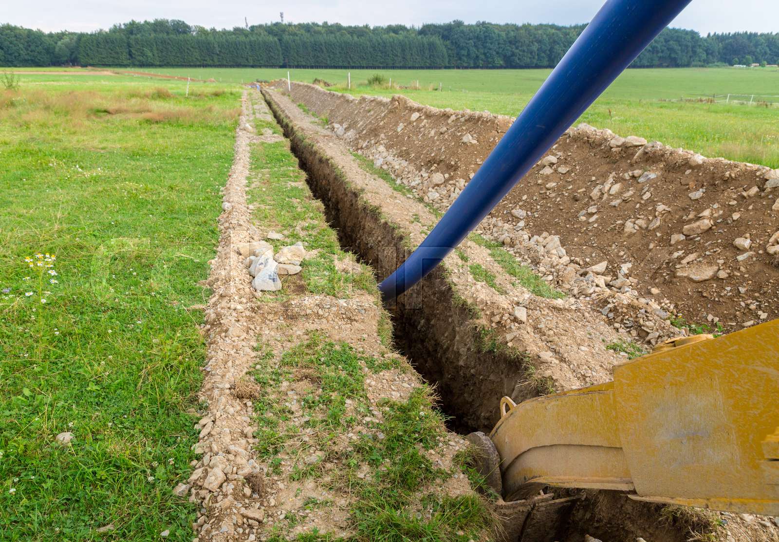 Pipe laying construction site on a meadow | Stock image | Colourbox