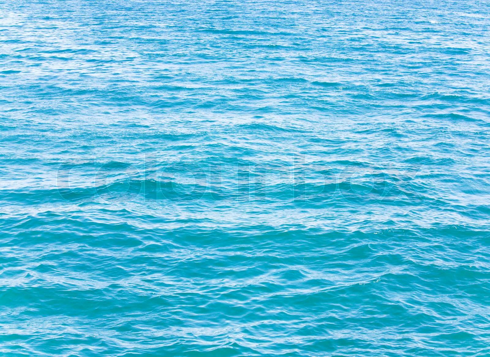 Azure sea water surface with ripple and cloud reflections | Stock image ...