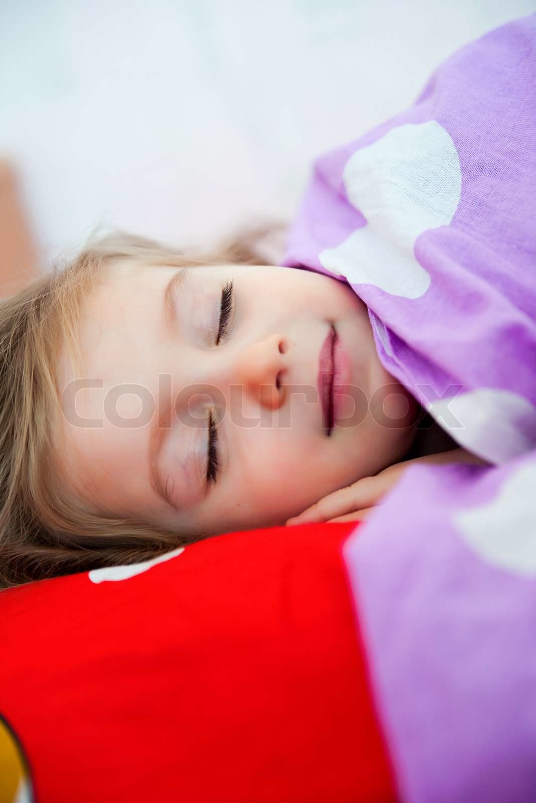 Cute sleep girl on the bed | Stock image | Colourbox