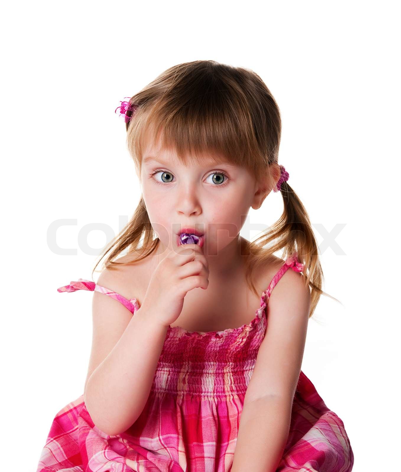 Pretty little girl with a bright lollipop | Stock image | Colourbox