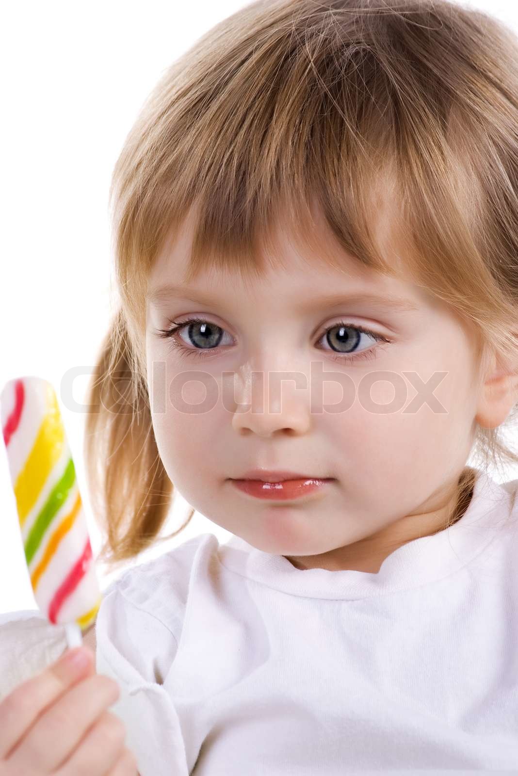 Hübsche kleine Mädchen mit einem hellen Lutscher | Stock Bild | Colourbox