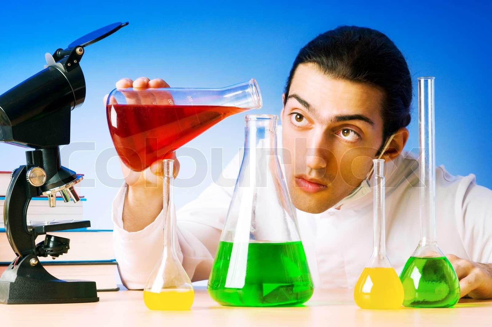 Chemist in the lab experimenting with solutions | Stock image | Colourbox