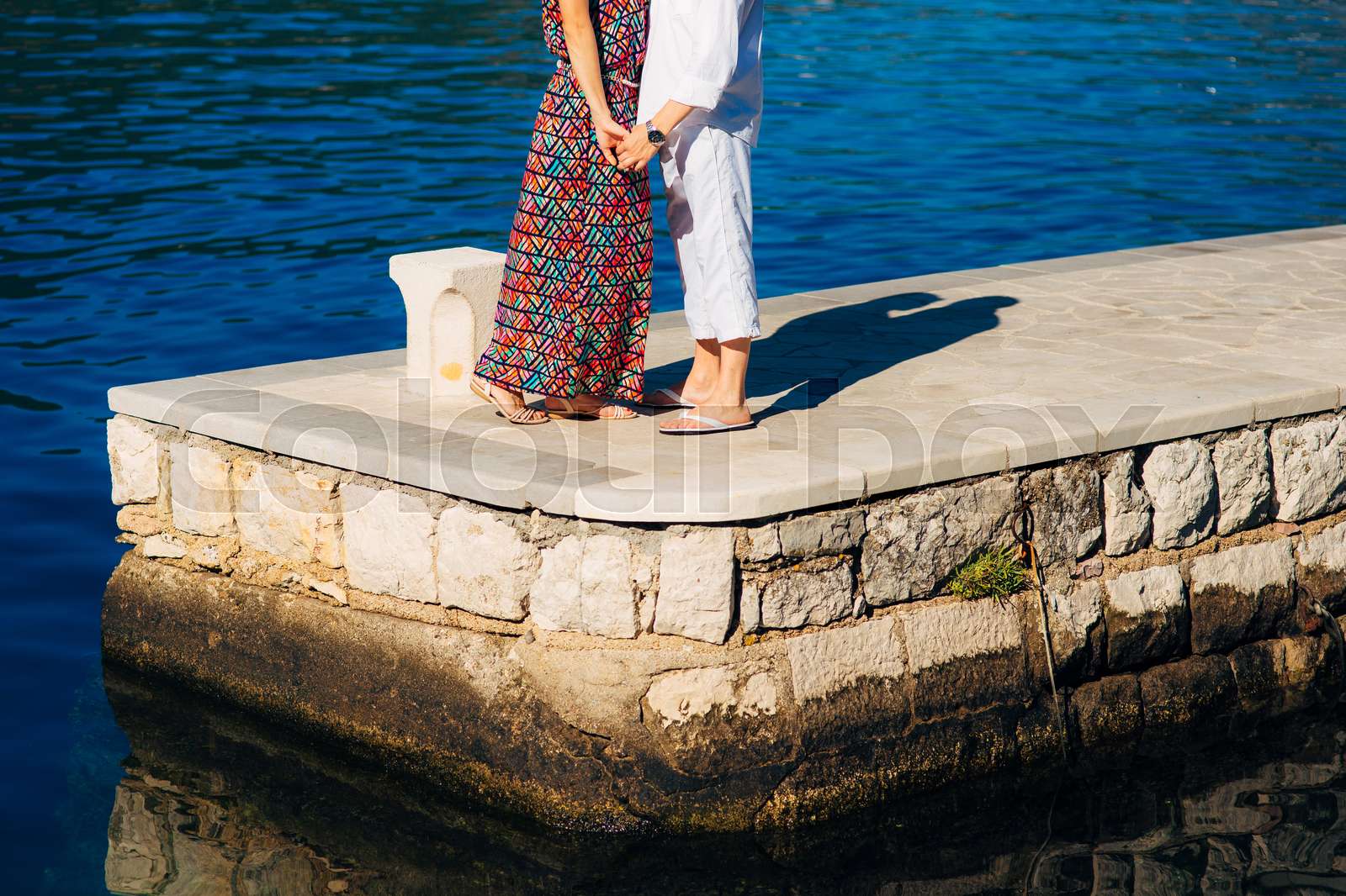 Female and male feet on the dock | Stock image | Colourbox