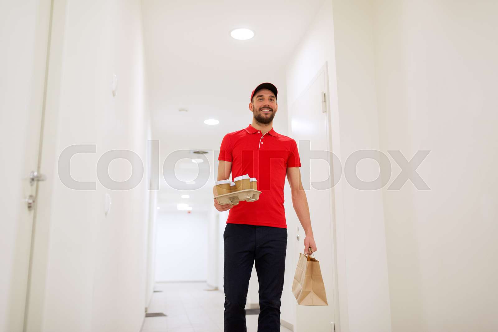 man delivering coffee and food to customer home | Stock image | Colourbox