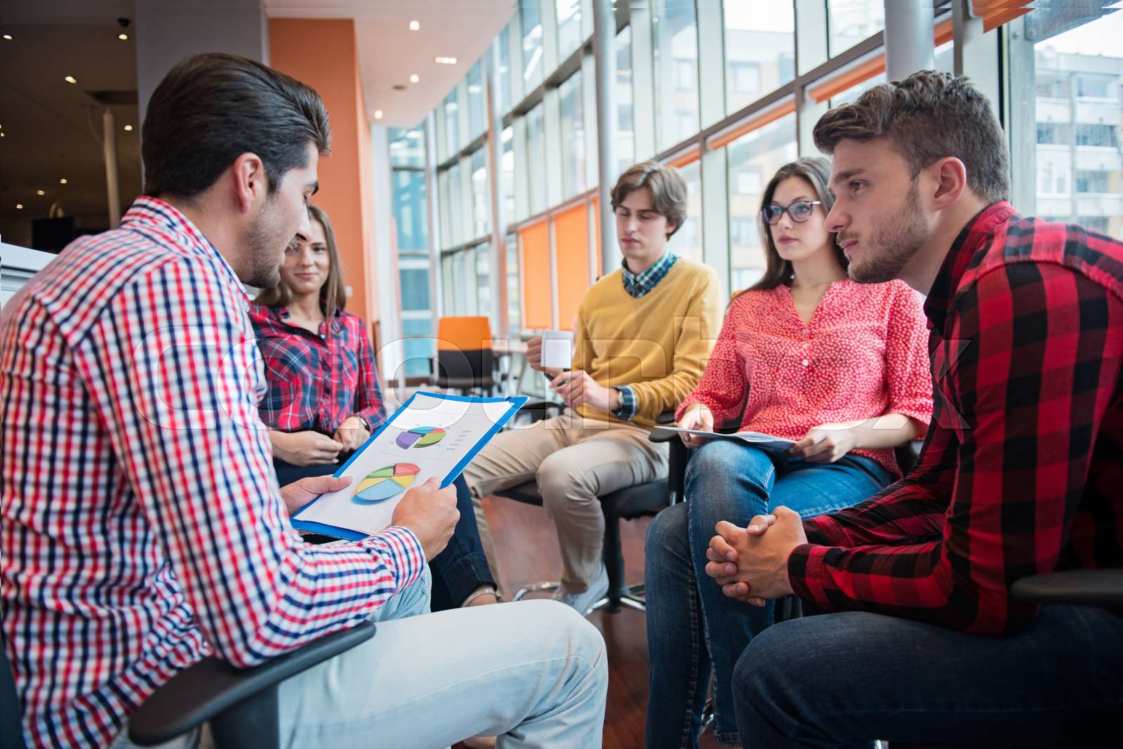 Shot of a group of young business professionals having a meeting ...