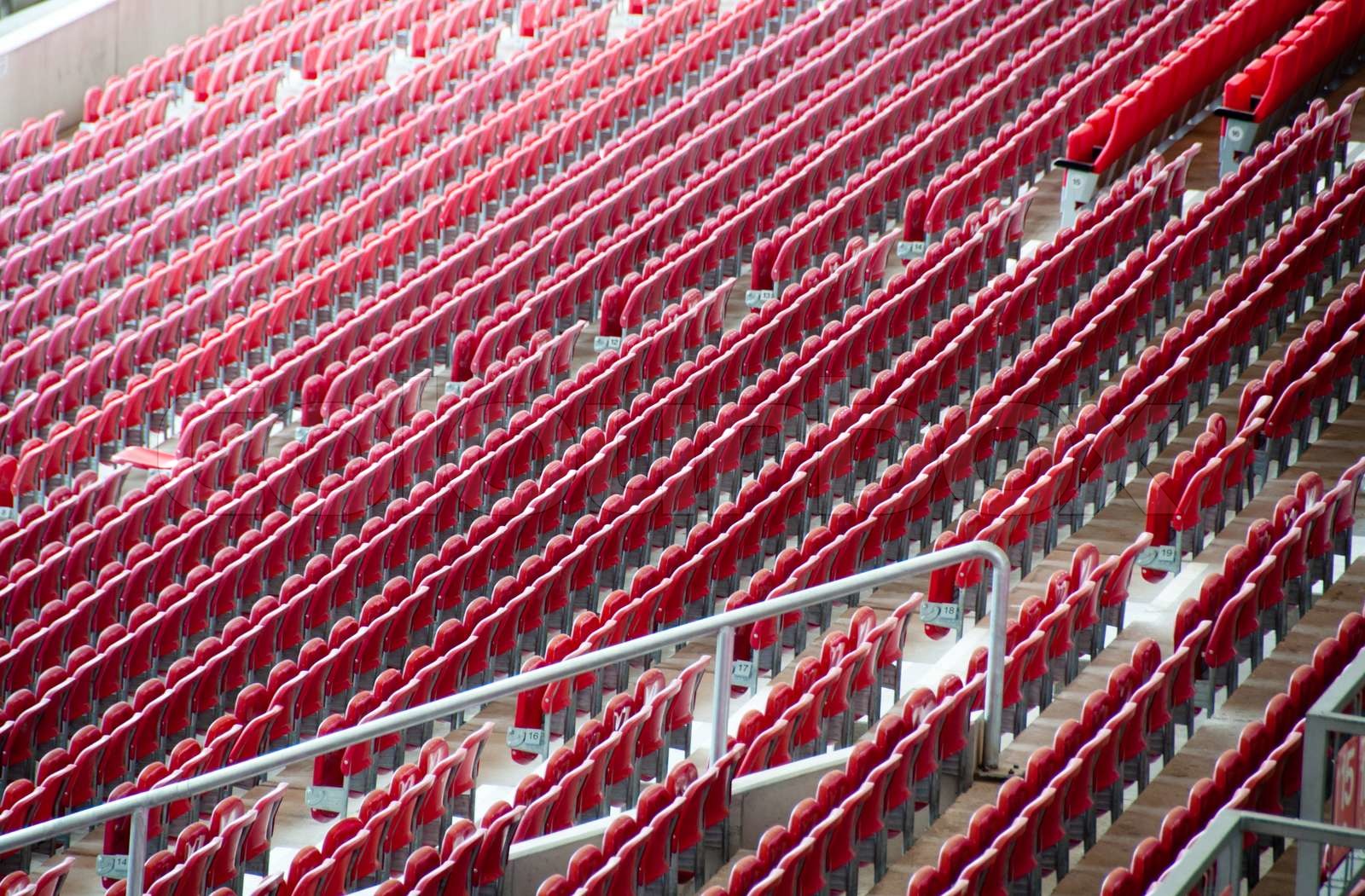 Rows of empty red seats in a football stadium | Stock image | Colourbox