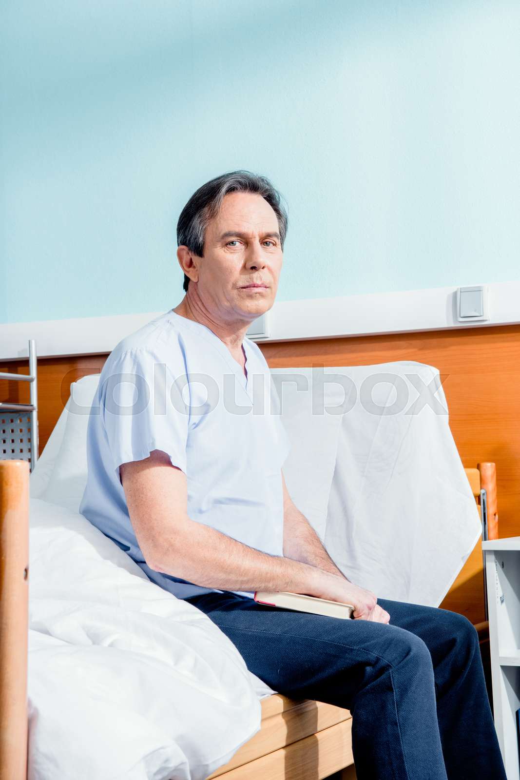 pensive mature man sitting on hospital bed | Stock image | Colourbox