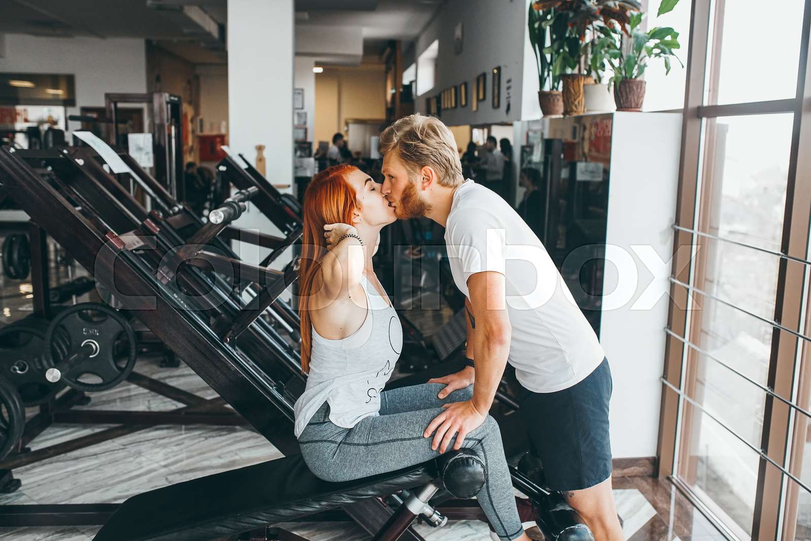 guy kiss girlfriend on training in gym | Stock image | Colourbox