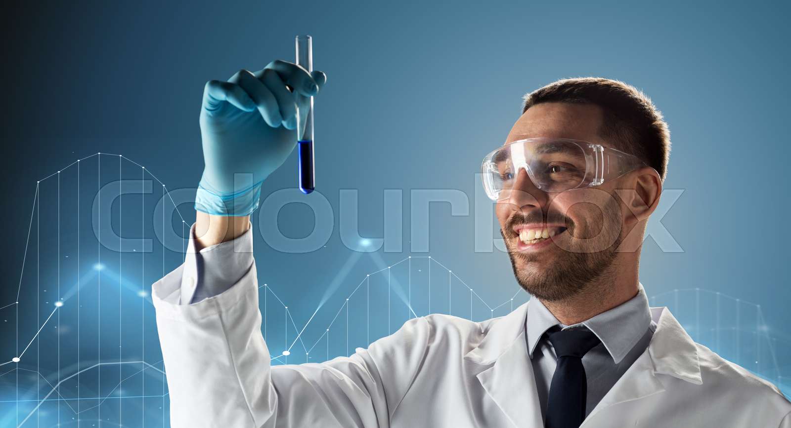 scientist in goggles with test tube and diagram | Stock image | Colourbox
