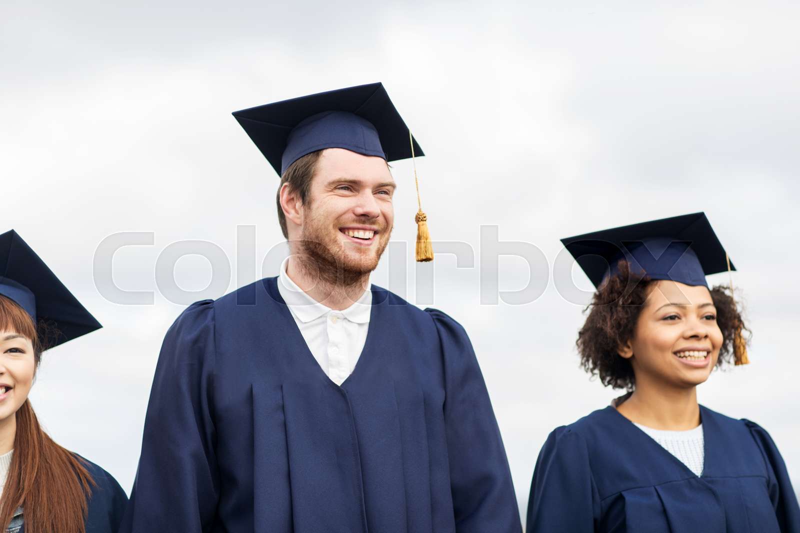 happy students or bachelors in mortar boards | Stock image | Colourbox