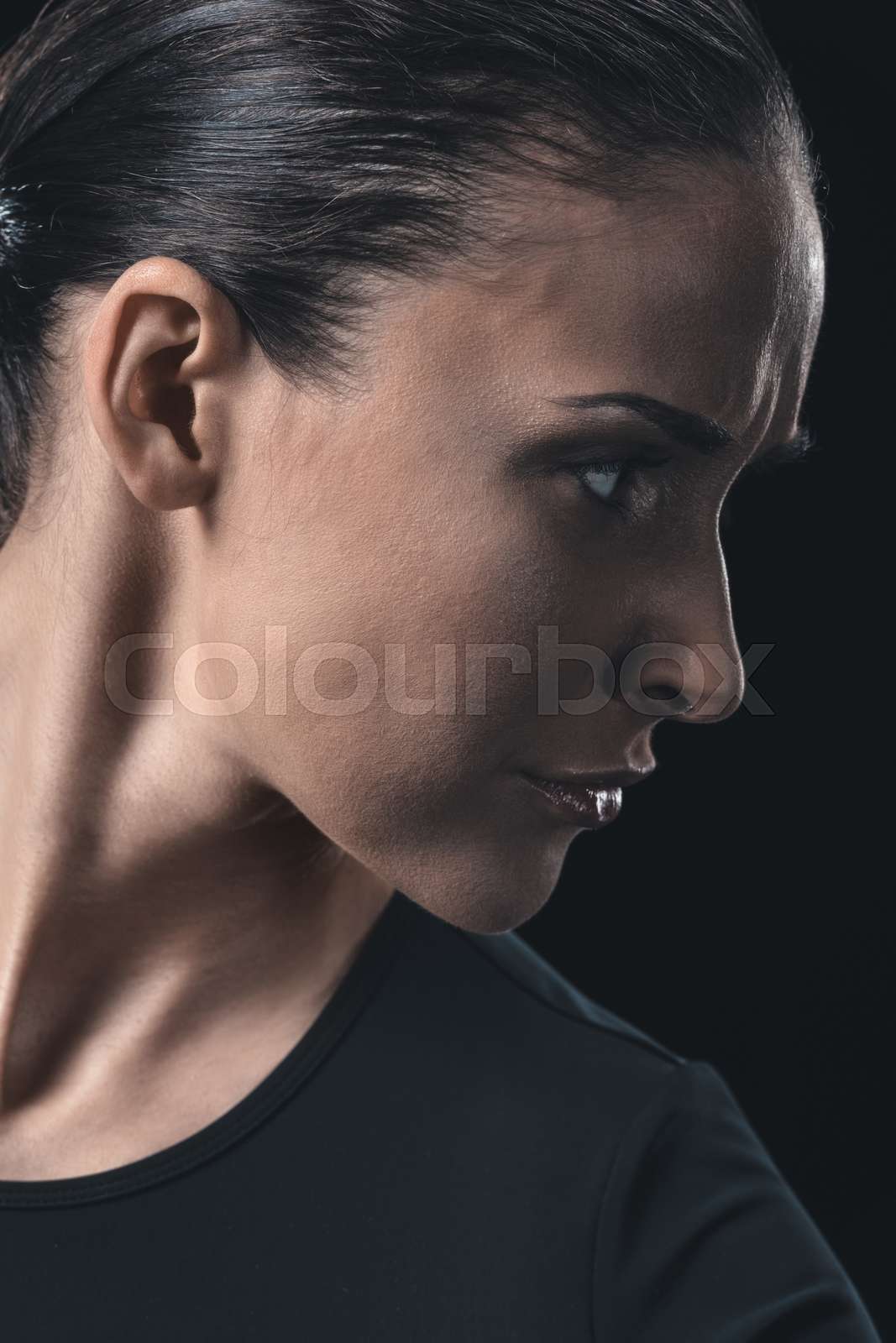side view portrait of attractive young woman isolated on black. | Stock ...