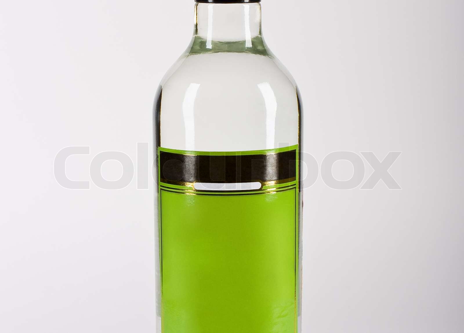 Flaske vodka med grønne mærkat på en hvid baggrund | Stock foto | Colourbox