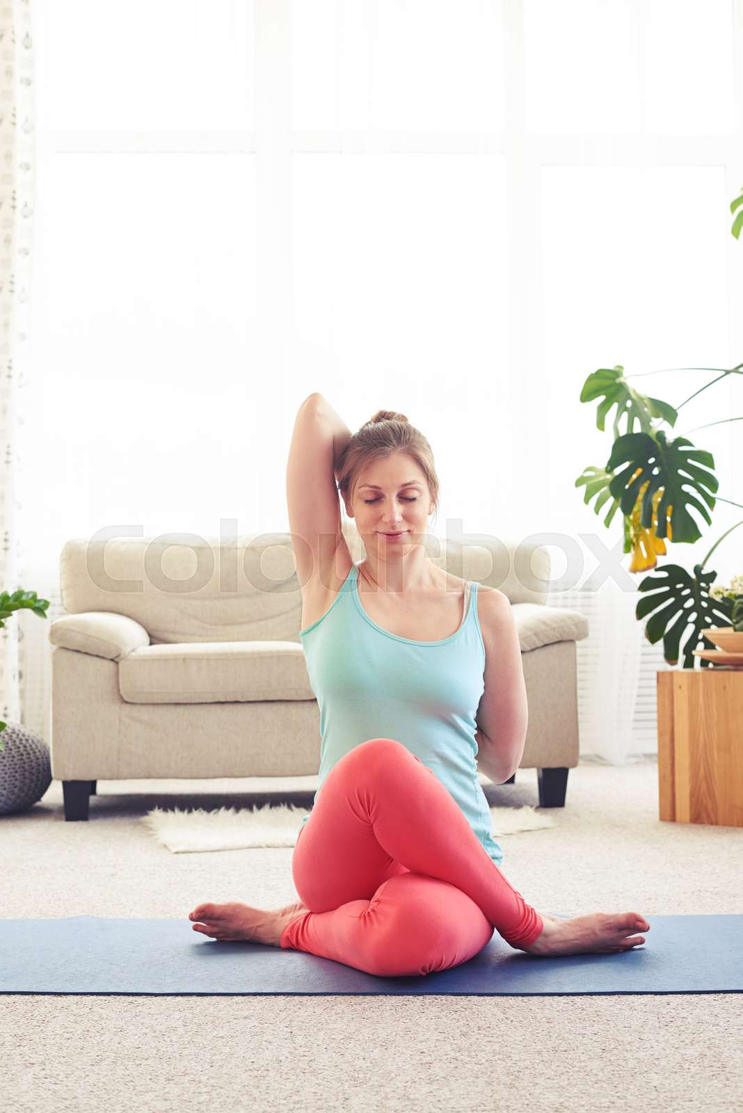Tranquil woman with hands in lock behind back | Stock image | Colourbox