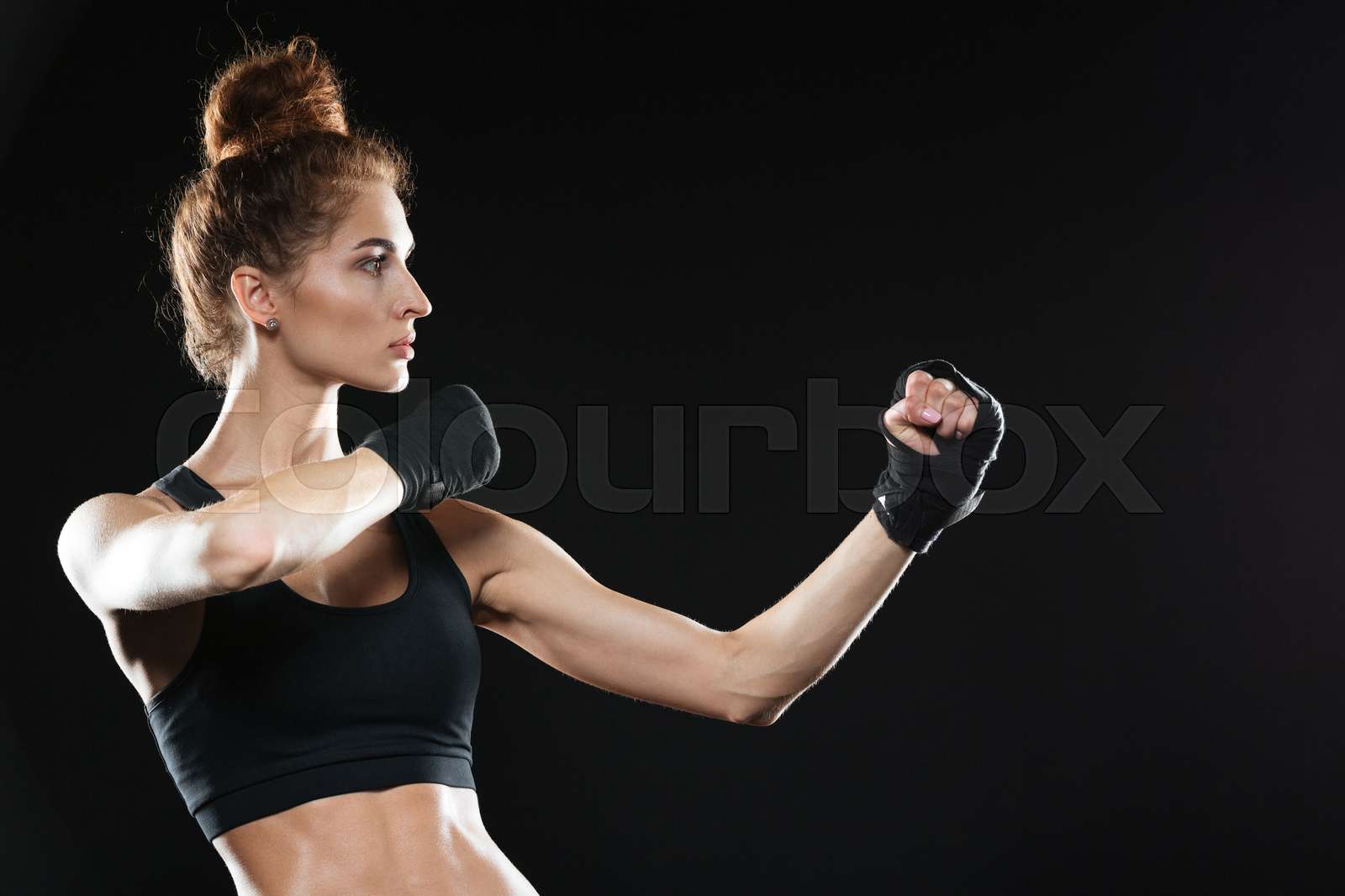Side view of Concentrated female fighter ready to fight | Stock image ...