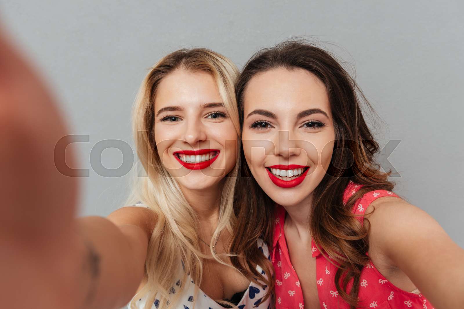 Pretty happy young women make selfie. | Stock image | Colourbox
