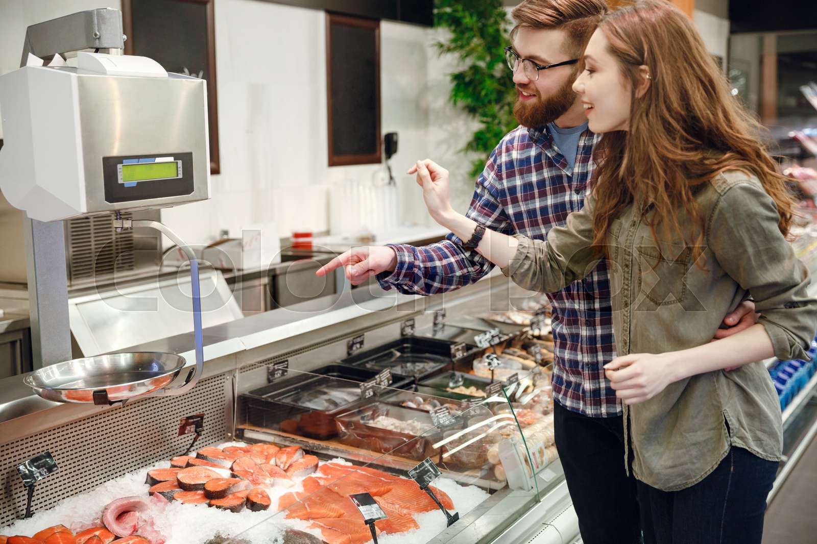 Side view of couple choosing fish | Stock image | Colourbox