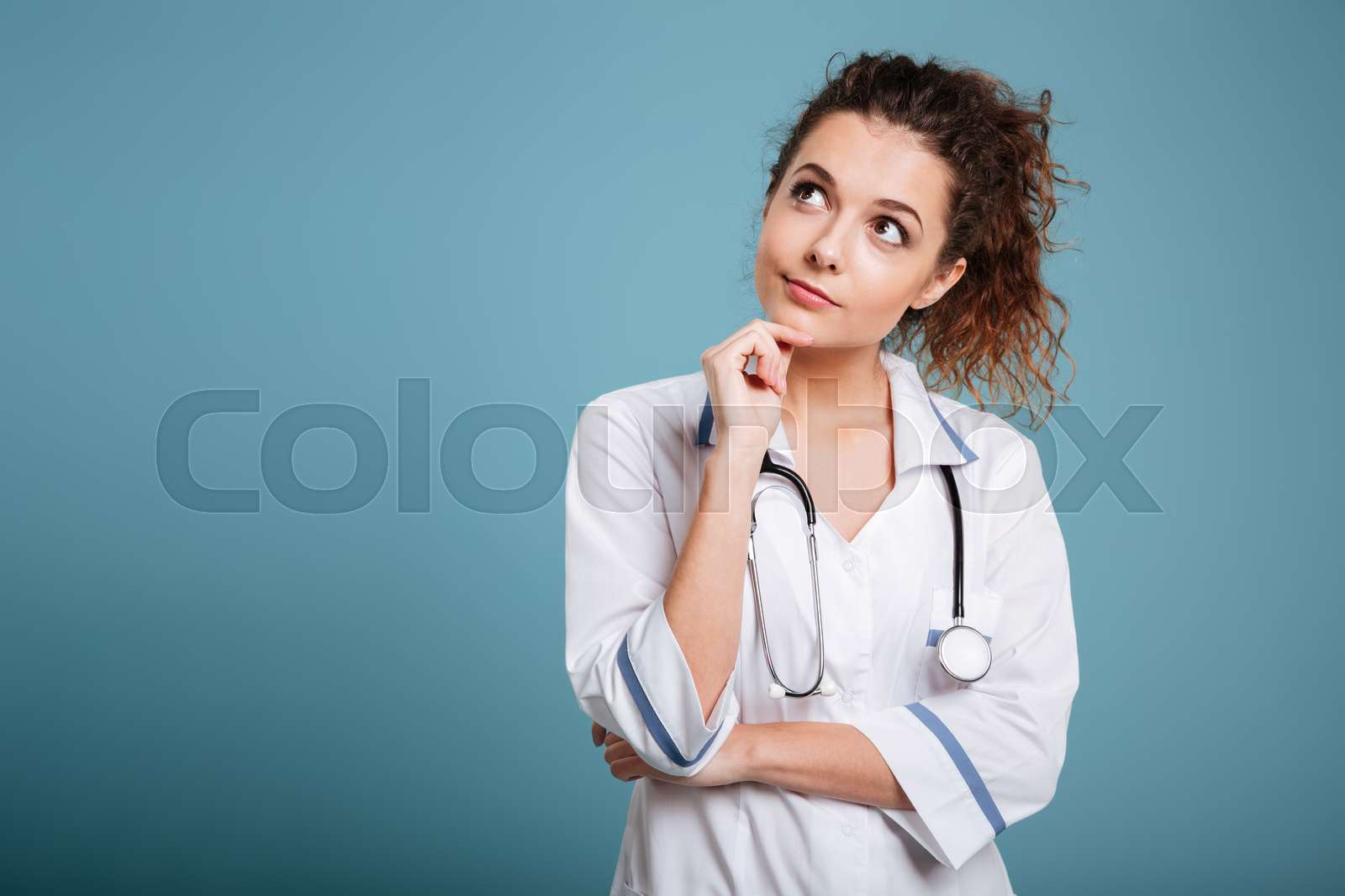 Portrait of a serious young nurse thinking and looking away | Stock ...