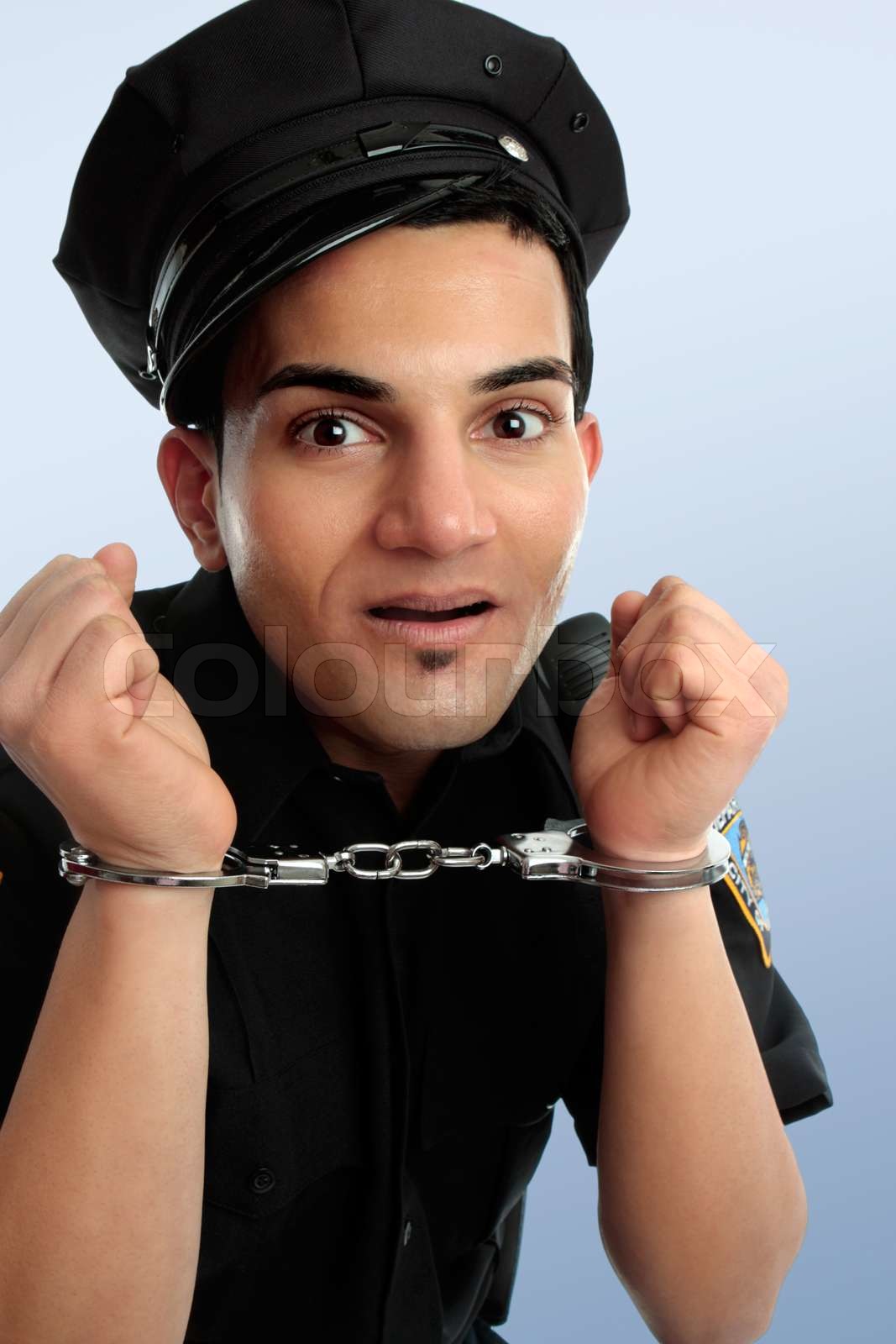Crazy policeman with hands in handcuffs arrest | Stock image | Colourbox