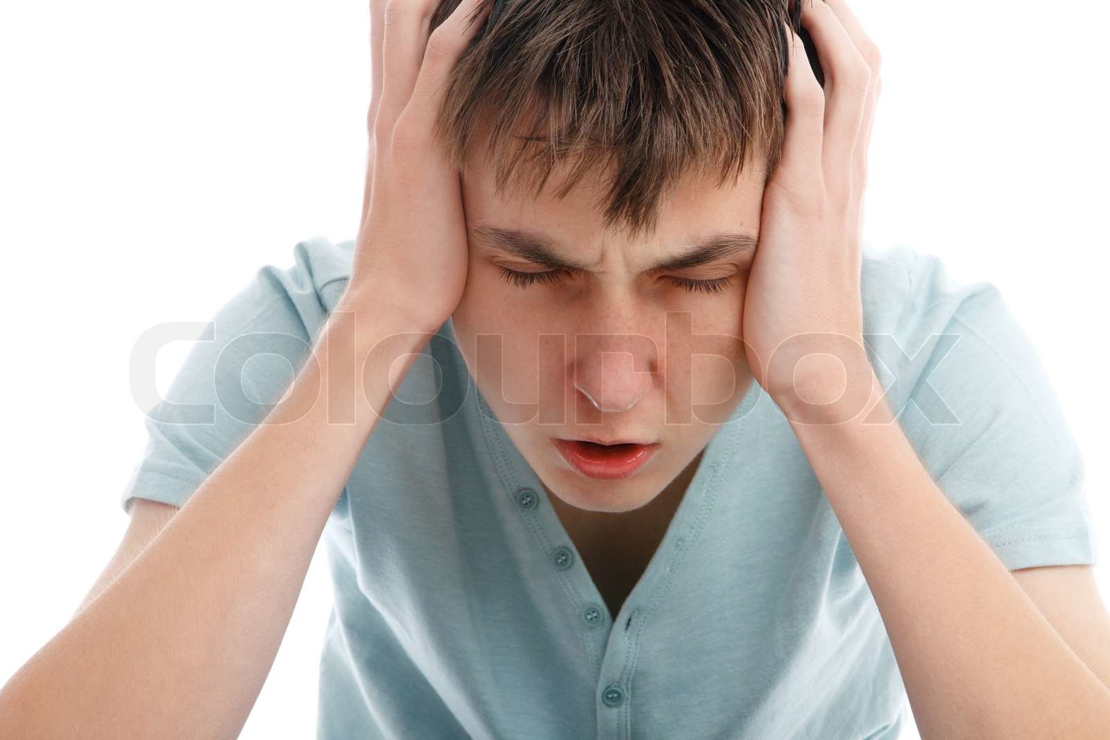 A teen boy showing signs of a headache, migrain or stress | Stock image ...