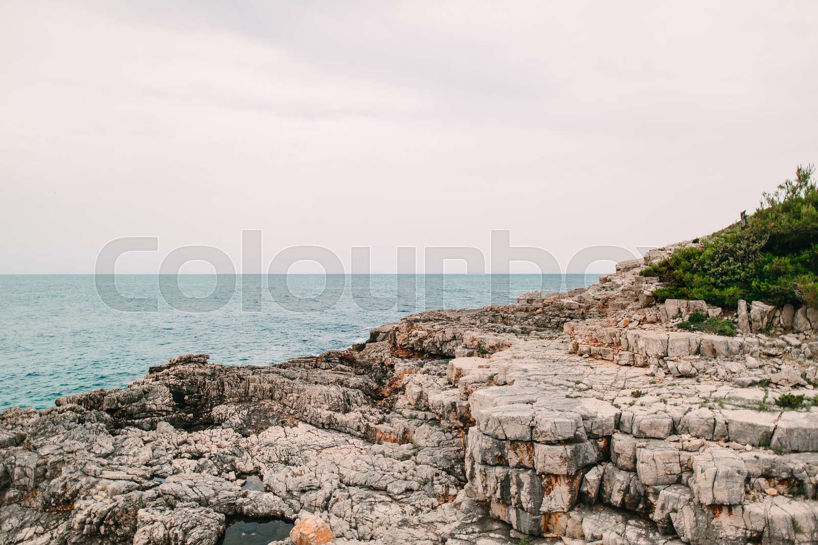 Rocks on the sea in Montenegro. Rocky coast. Wild beach. Dangero ...