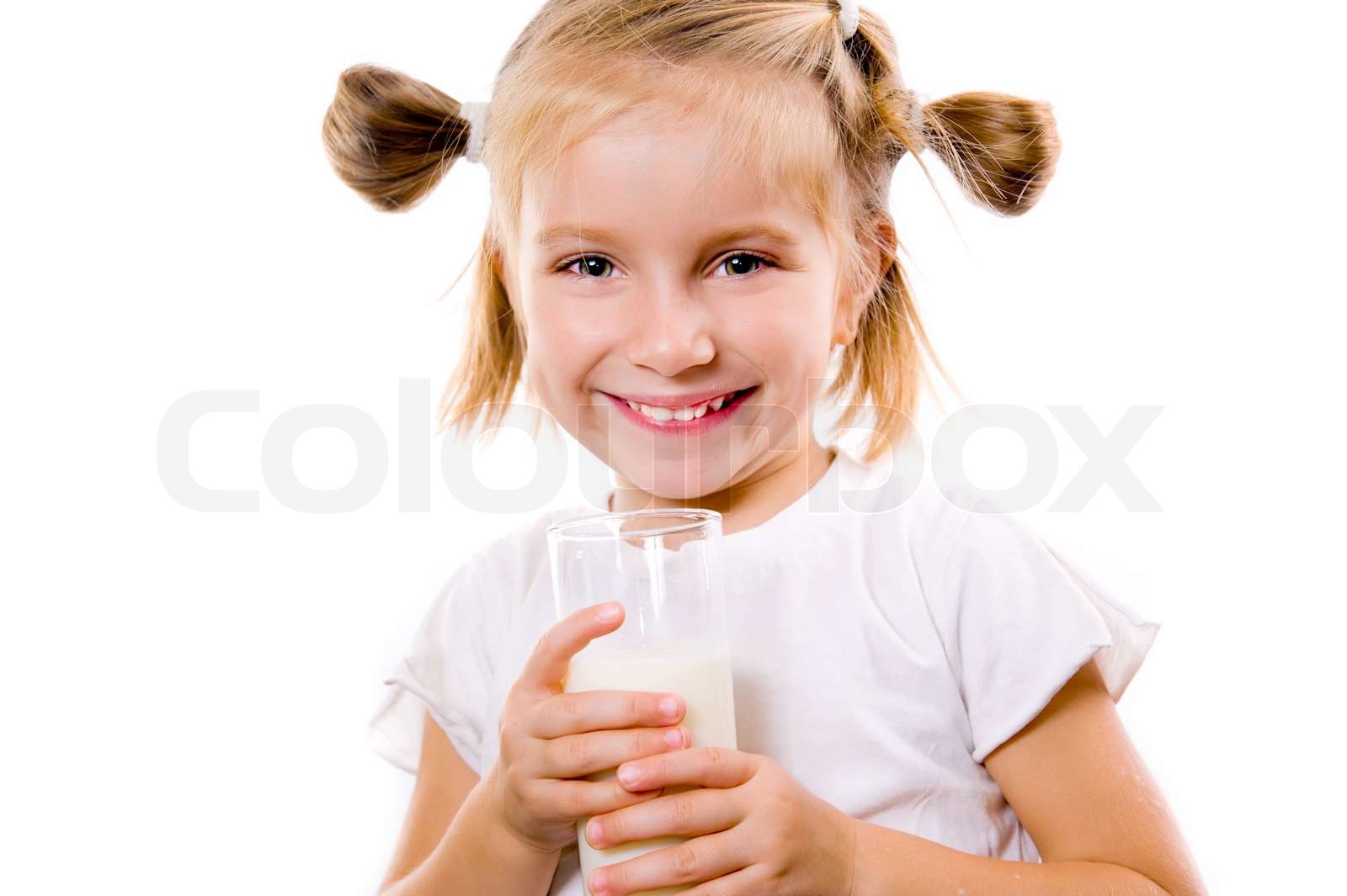 Portrait of a little girl holding a cup of milk, isolated on white ...