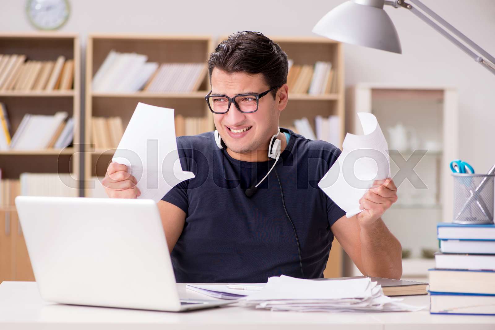 Angry man tearing apart his paperwork due to stress | Stock image ...