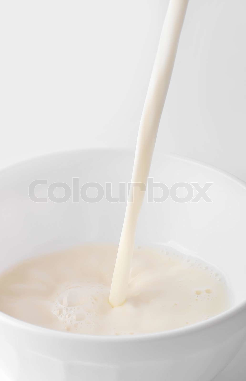 The milk flowing into the cup | Stock image | Colourbox
