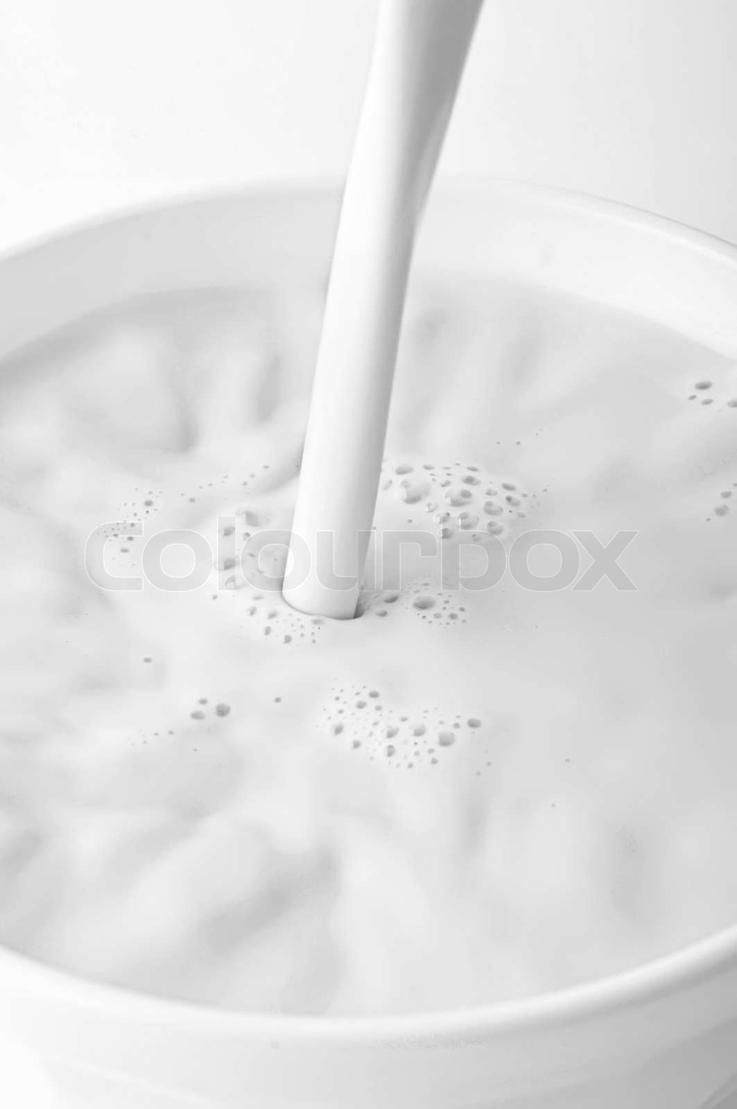 The milk flowing into the cup | Stock image | Colourbox