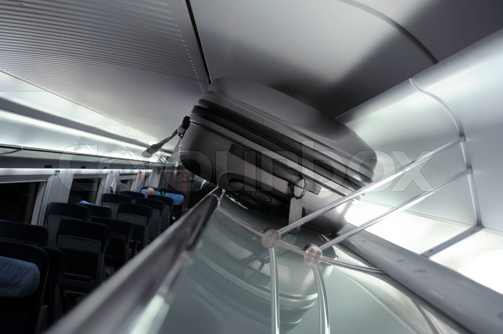 This photograph represent a suitcase on luggage rack in train | Stock ...