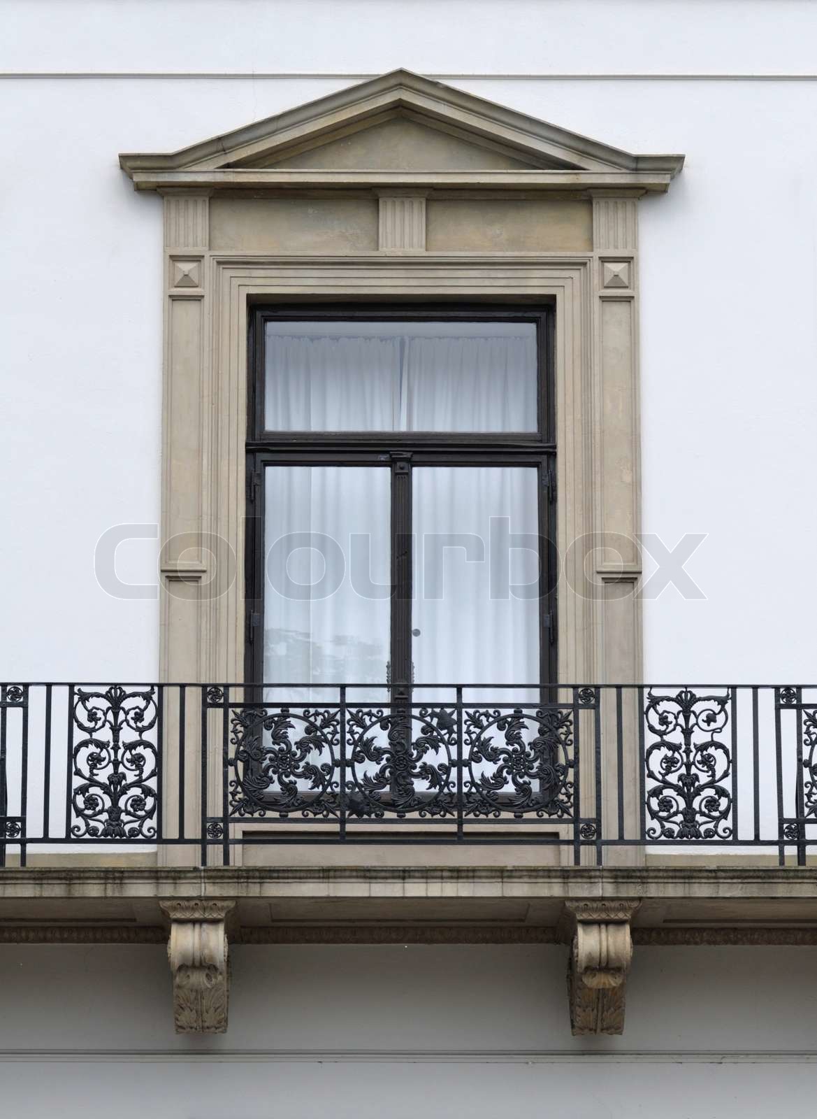 This photograph represent a detailed window and balcony from front ...