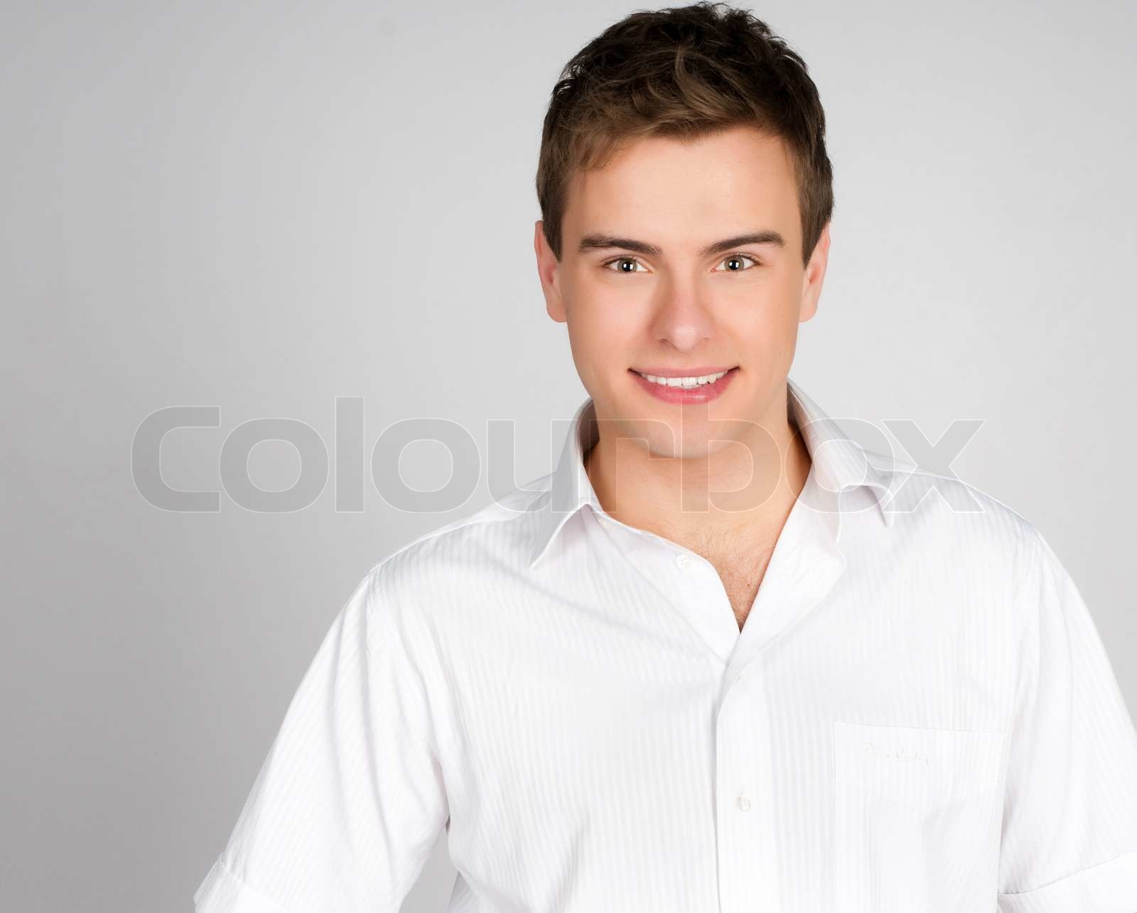 handsome young man smiles and looks into the camera | Stock image ...