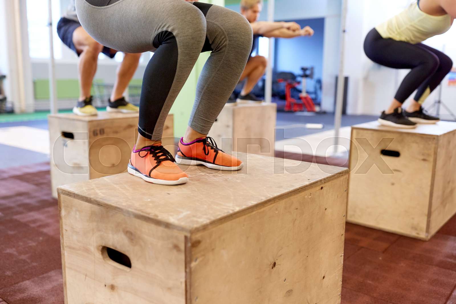 group of people doing box jumps exercise in gym | Stock image | Colourbox